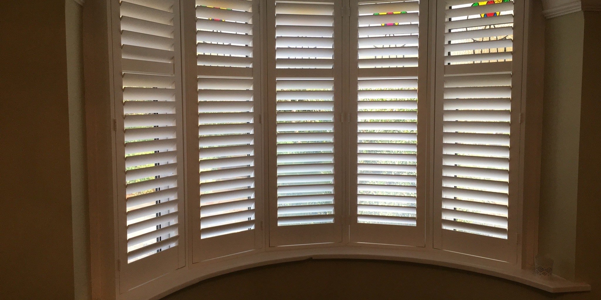5 panel curved bay window, fitted with plantation shutters in Worsley ...